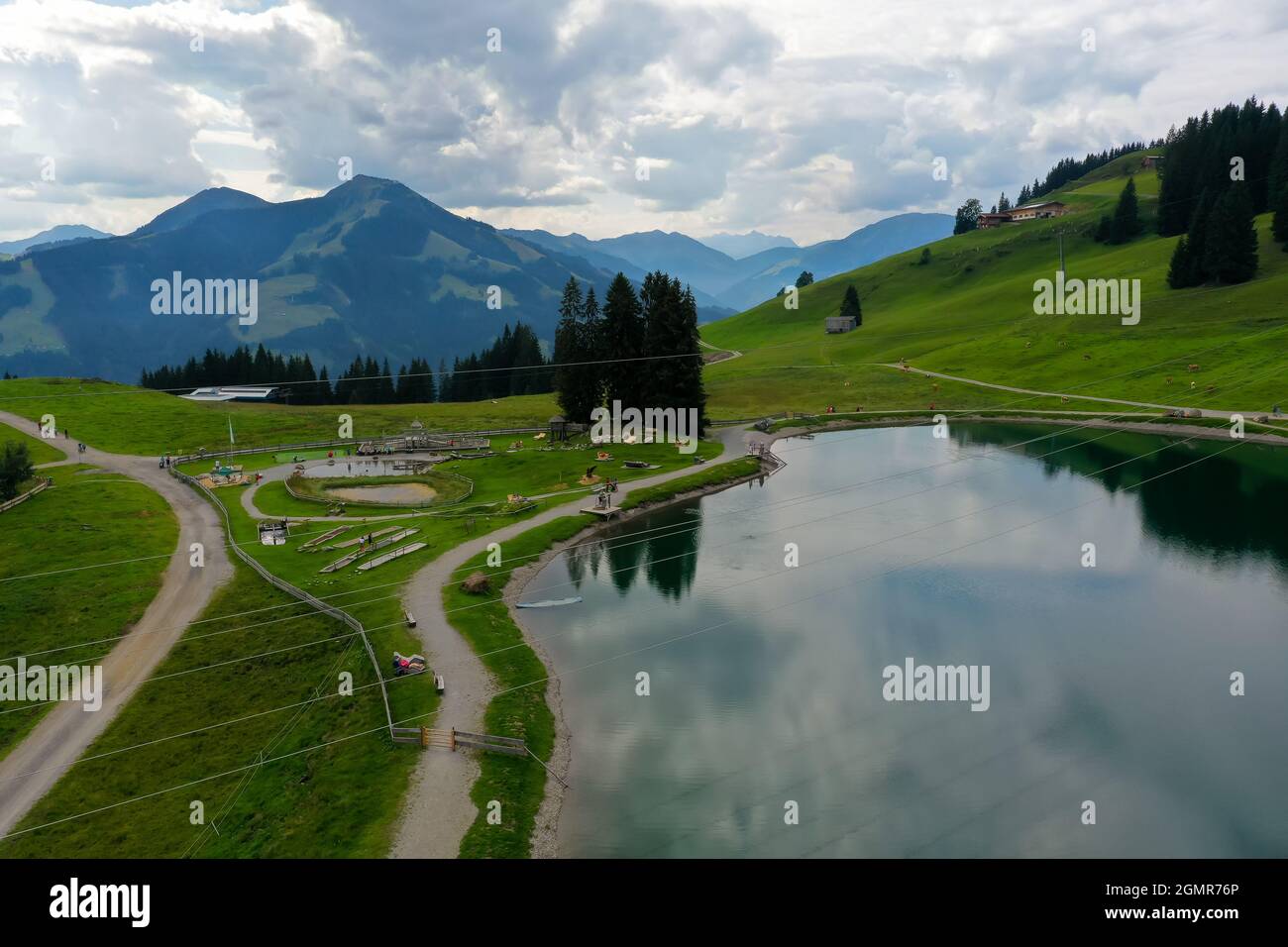 Landscape of the Filzalmsee surrounded by hills covered in greenery in ...