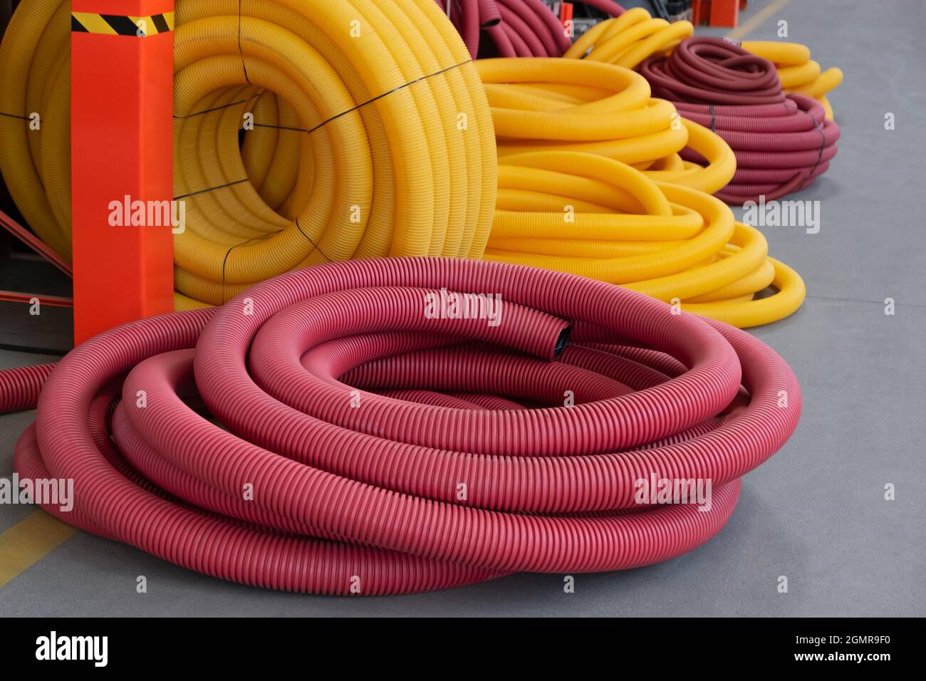 Yellow and Red Coil Land Drainage flexible Pipe Hose Slotted heap on ...