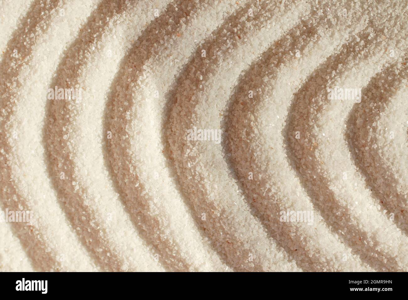 Quartz sand.Round waves on sand Stock Photo - Alamy