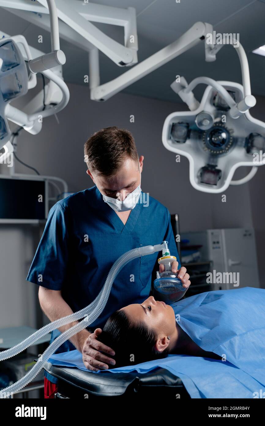 The doctor puts on a mask for artificial ventilation of the lungs in ...