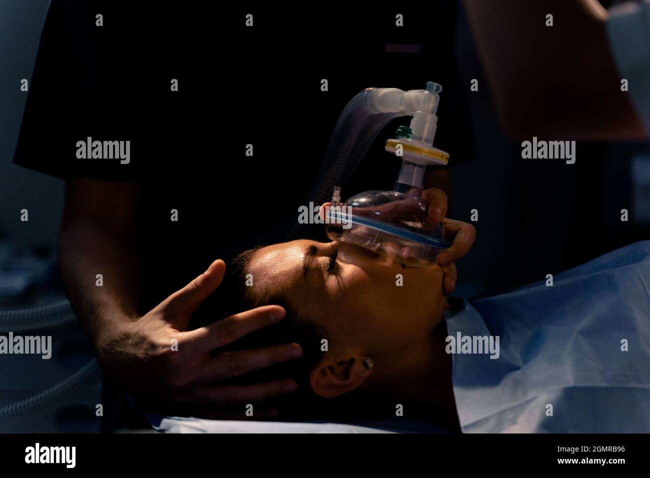 The doctor puts on a mask for artificial ventilation of the lungs in ...