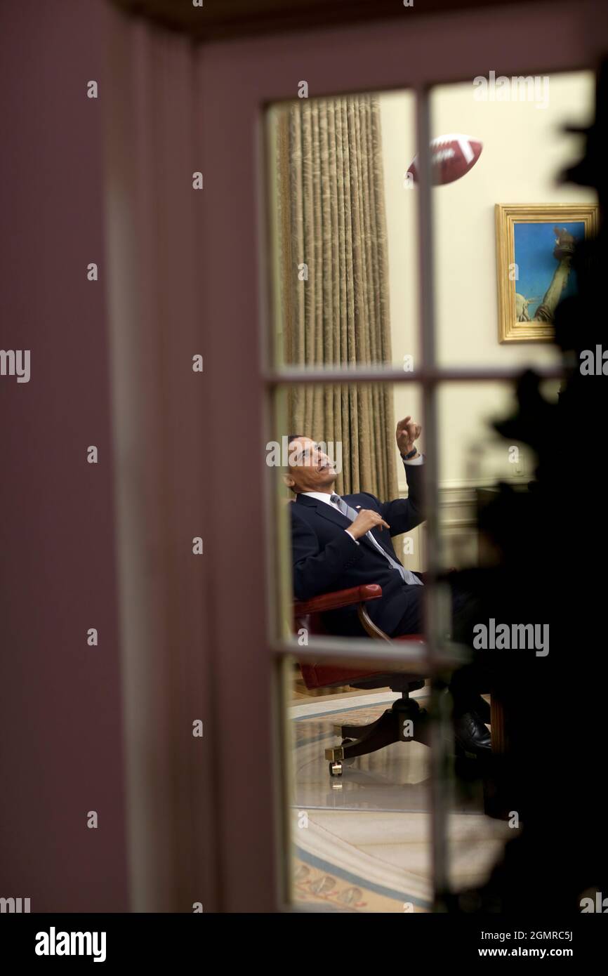 President Barack Obama plays with a football in the Oval Office 4/23/09 ...