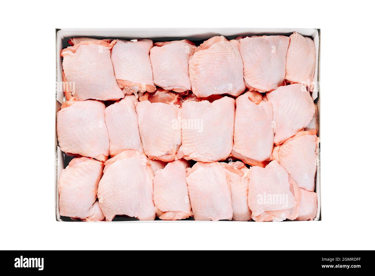 Fresh chicken thigh with skin many pieces close-up in a cardboard box ...
