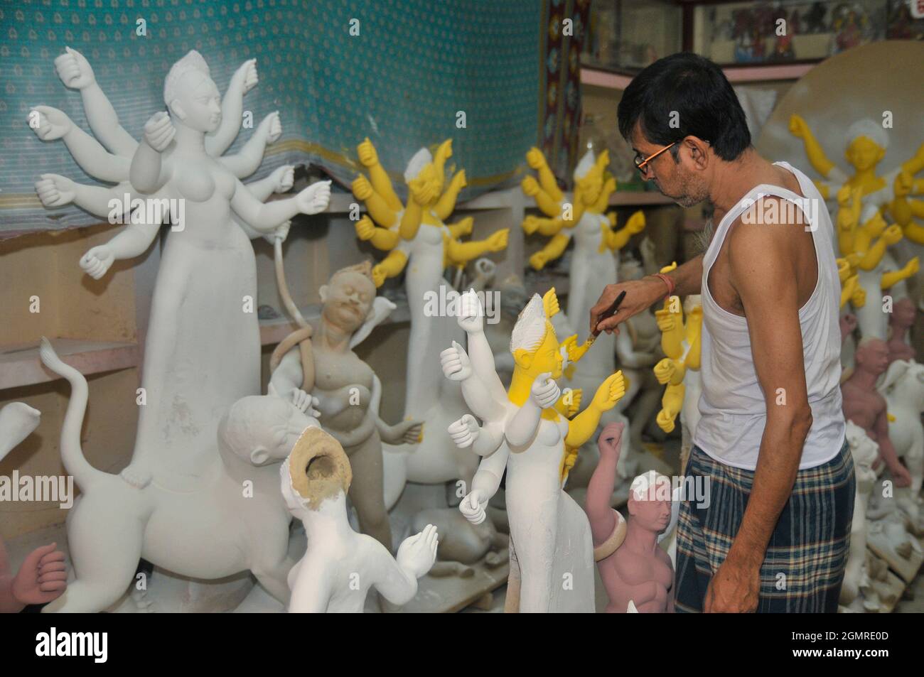 Non Exclusive: Artist Gourango Paul paints a sculpture of Goddess Durga ...