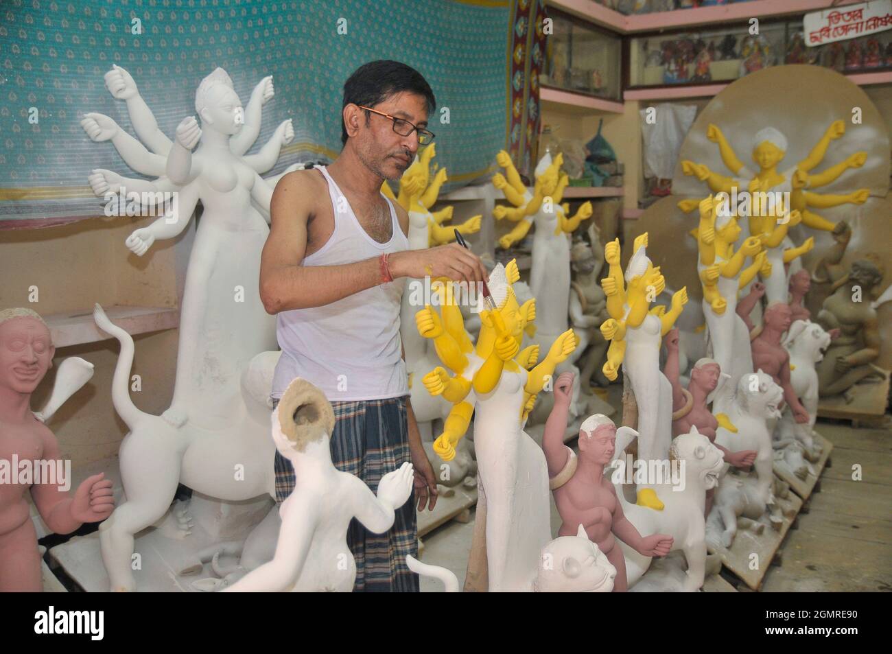 Non Exclusive: Artist Gourango Paul paints a sculpture of Goddess Durga ...