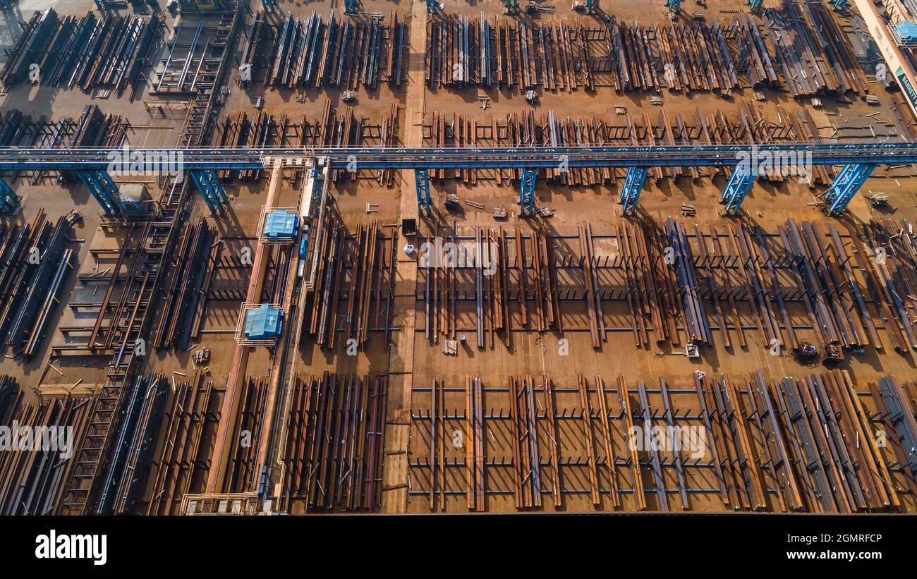Steel beams, rusty and clean, by the warehouse in industrial estate ...