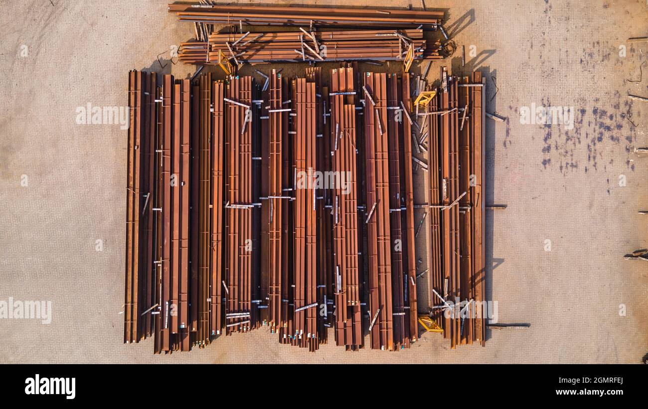 Steel beams, rusty and clean, by the warehouse in industrial estate ...