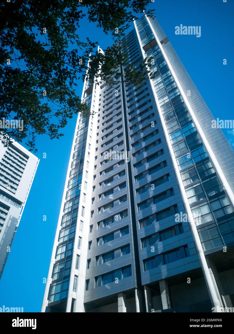 Vertical shot of a modern skyscraper on a blue sky background Stock ...