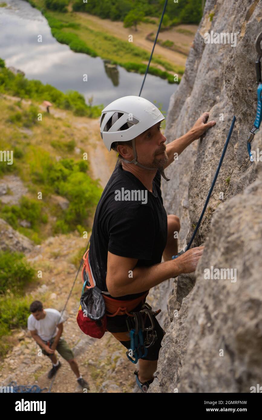 Senior fit guy is climbing the high hill while thinking about his next ...
