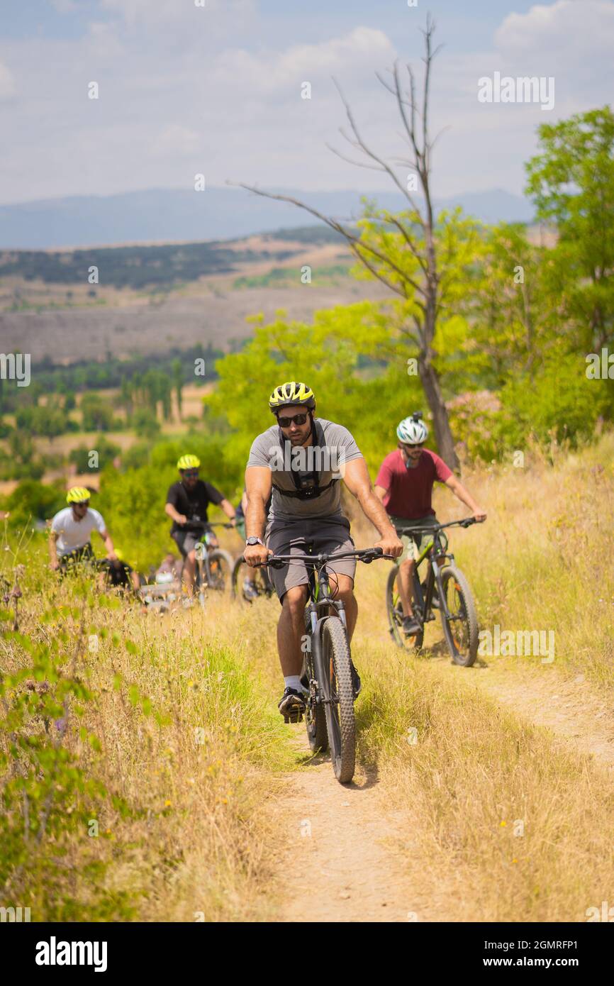 Group of friends riding bikes on a forest trail hi-res stock ...