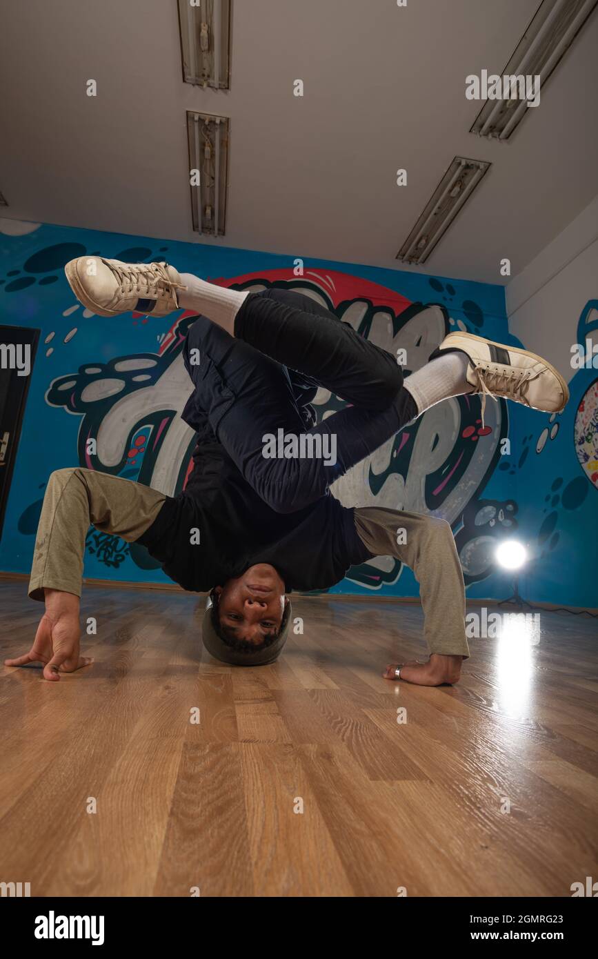 Modern rapper dancing in garage. Urban lifestyle, hip hop Stock Photo ...