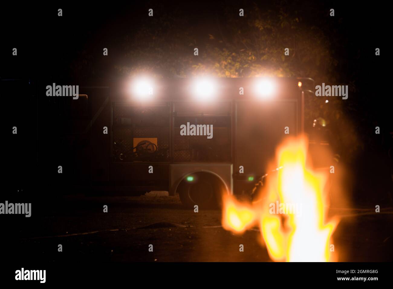 Firefighting group in action battling flames during night time Stock ...