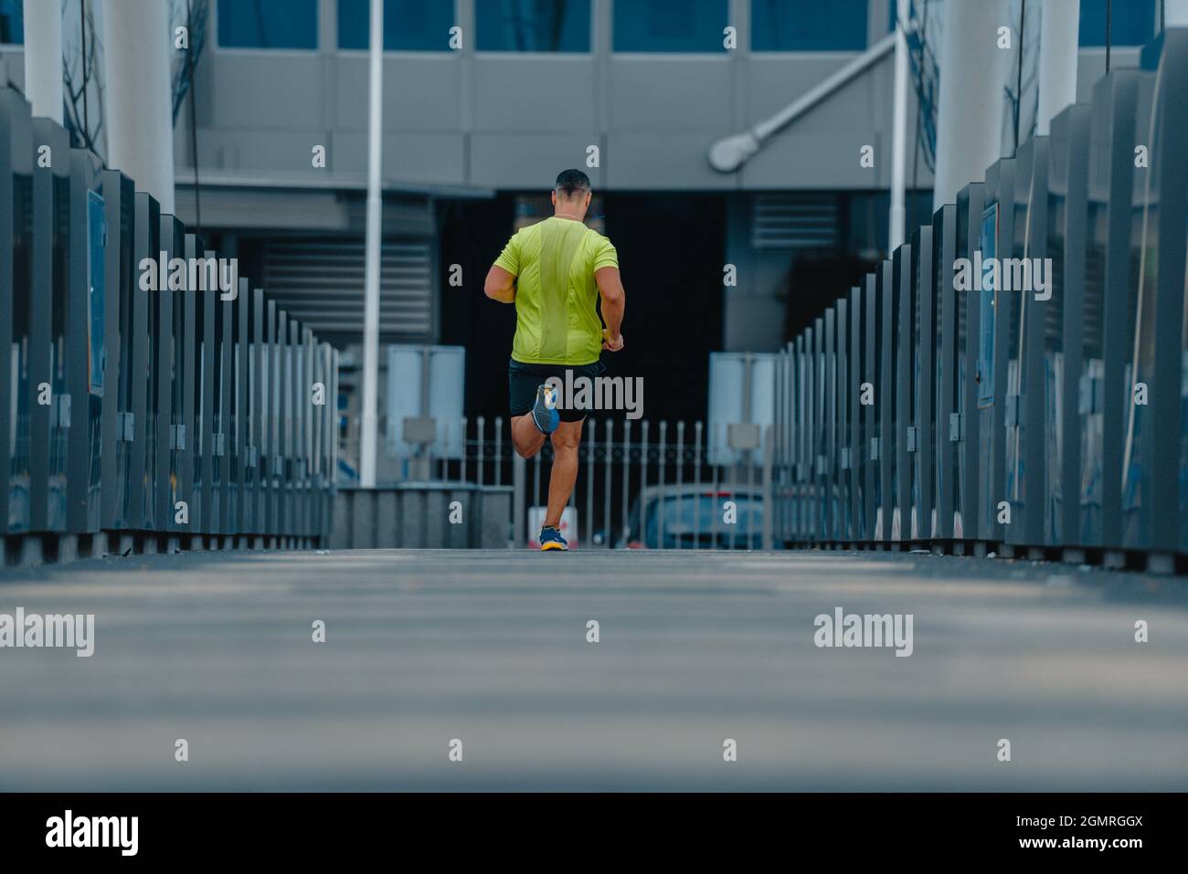 Well built man over 40 wearing activewear training gear running on a ...