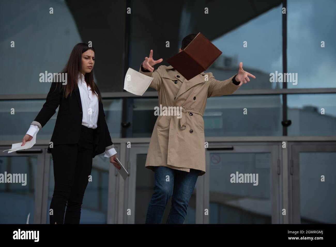 Businessman is throwing his notebook out of anger while his partner is ...
