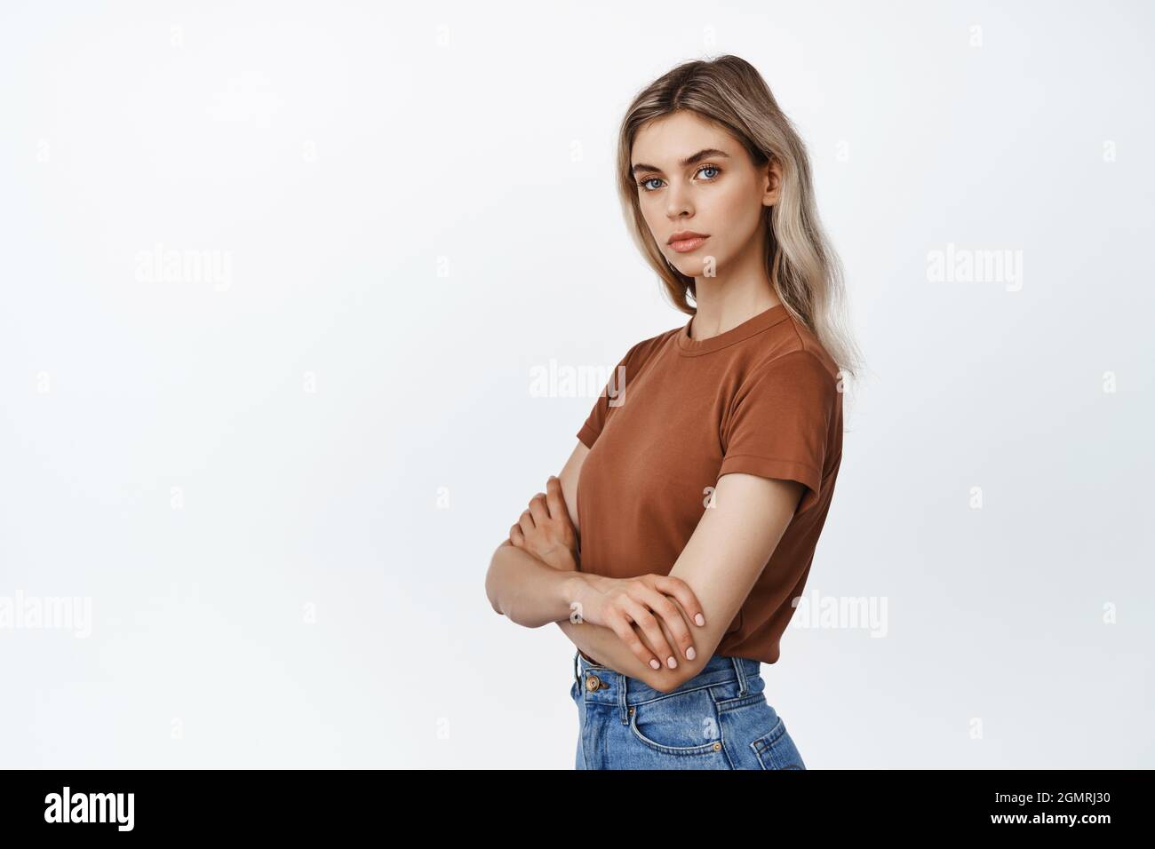 Blond confident woman looking like professional, cross arms on chest ...