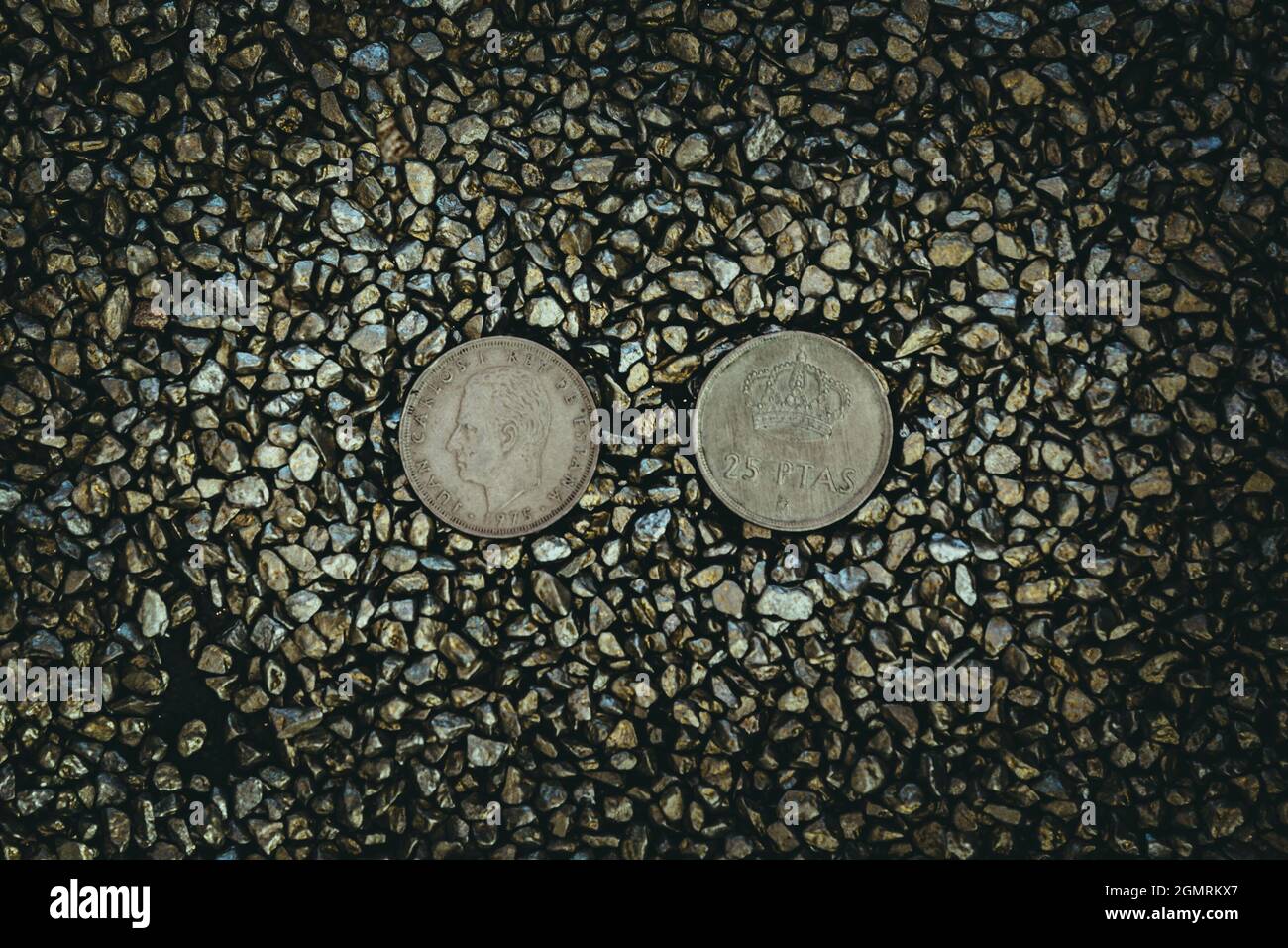 Top view of rusty old and worn out coins placed on the ground with tiny ...