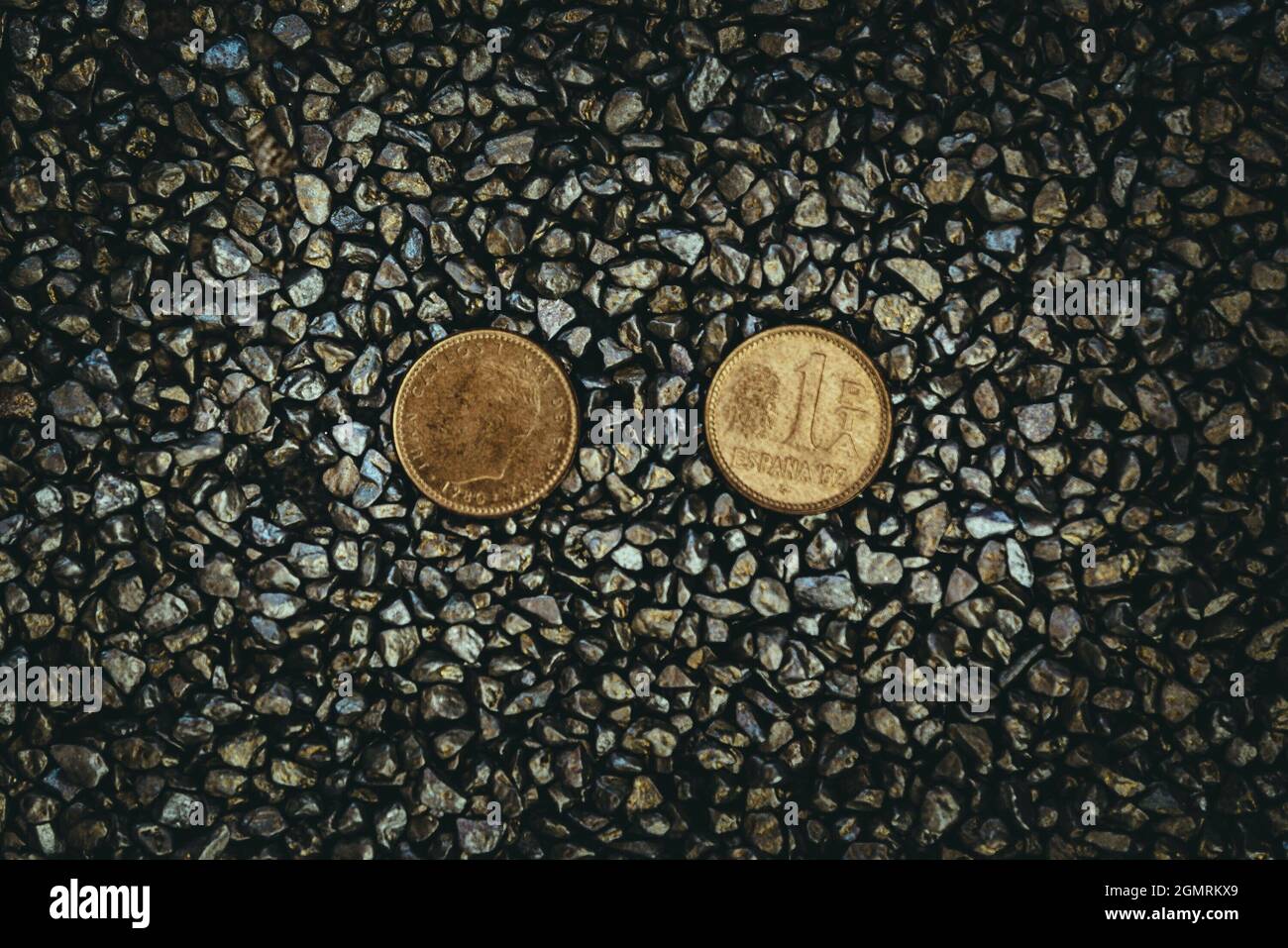 Top view of rusty old and worn out coins placed on the ground with tiny ...