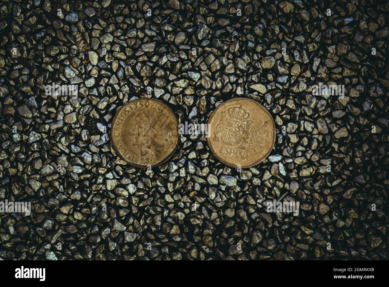 Top view of rusty old and worn out coins placed on the ground with tiny ...