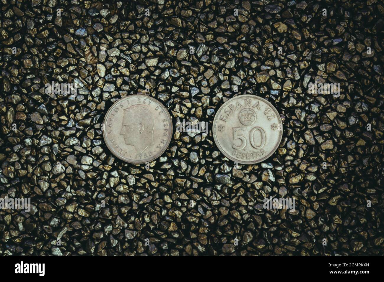 Top view of rusty old and worn out coins placed on the ground with tiny ...