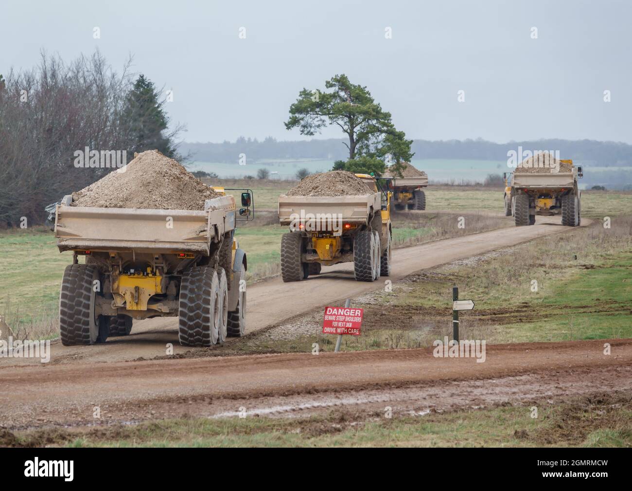 four yellow Volvo A40E articulated dump truck earth mover with 25 tonne ...