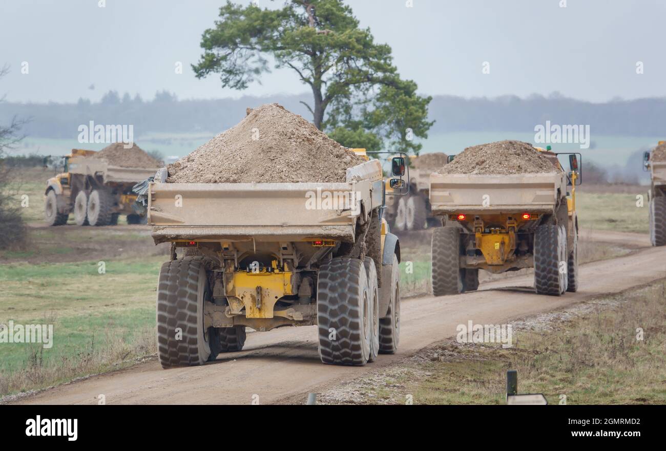 four yellow Volvo A40E articulated dump truck earth mover with 25 tonne ...