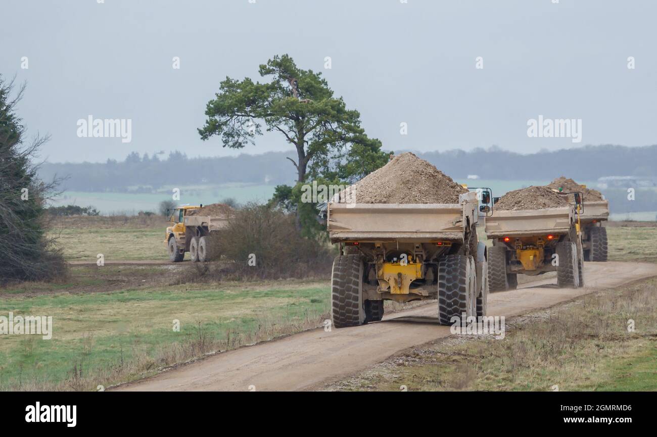 four yellow Volvo A40E articulated dump truck earth mover with 25 tonne ...