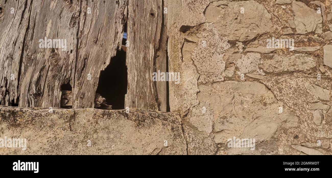 View of a tiny hole in the wooden door next to the wall looking from ...