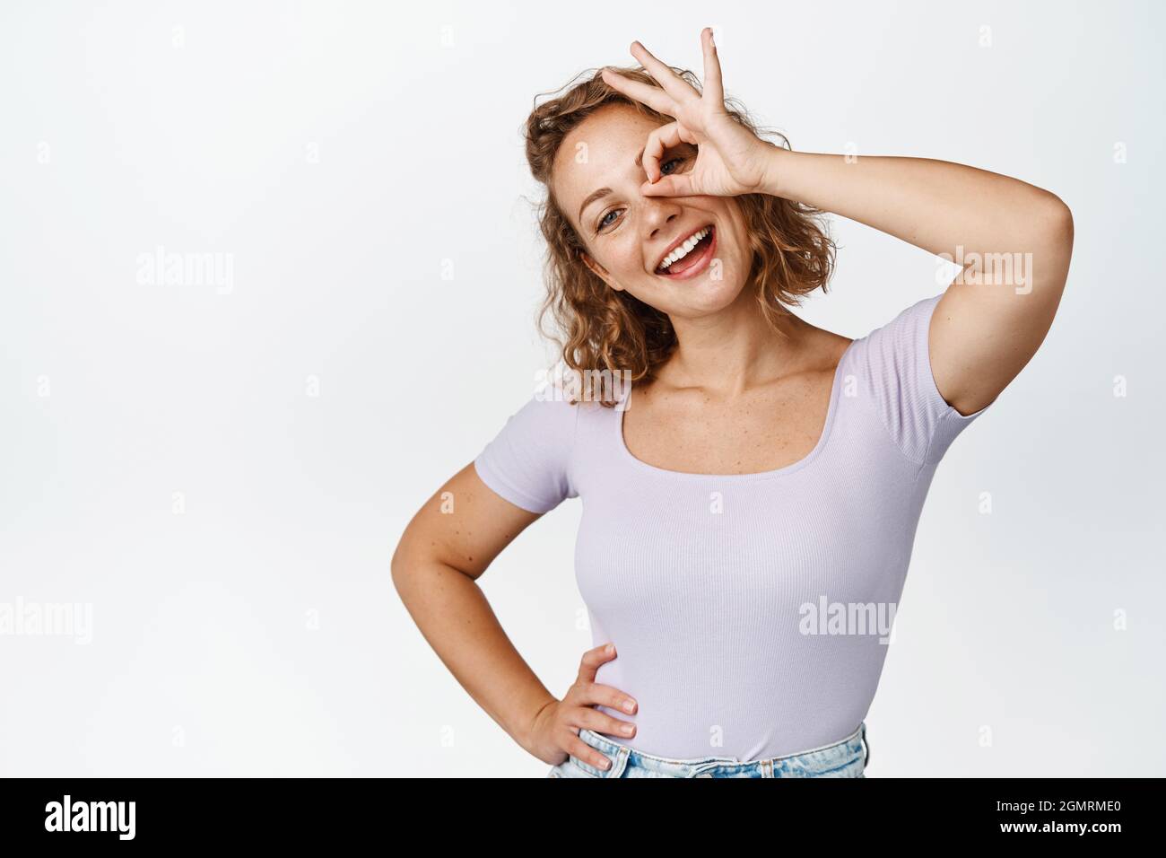 Positive blond girl shows okay sign on eye, zero no problem gesture ...