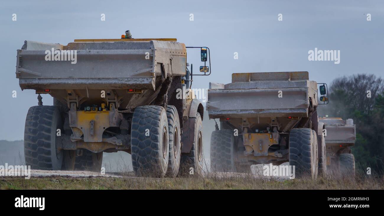 three yellow Volvo A40E articulated dump truck earth mover with 25 ...