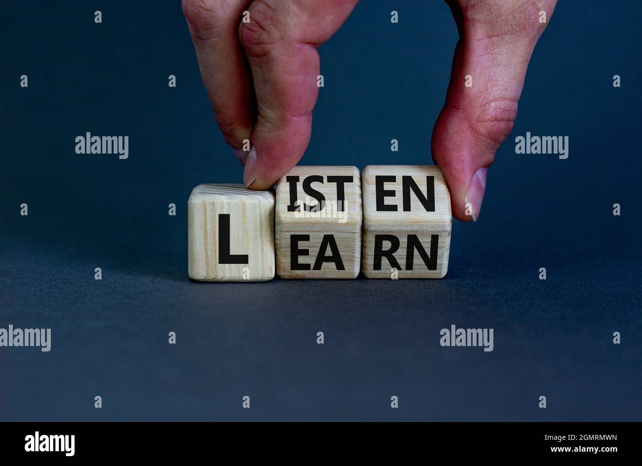 Listen and learn symbol. Businessman turns wooden cubes and changes a ...