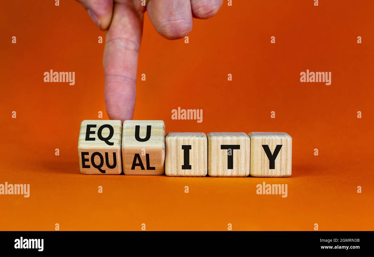 Equity and equality symbol. Businessman turns wooden cubes and changes ...