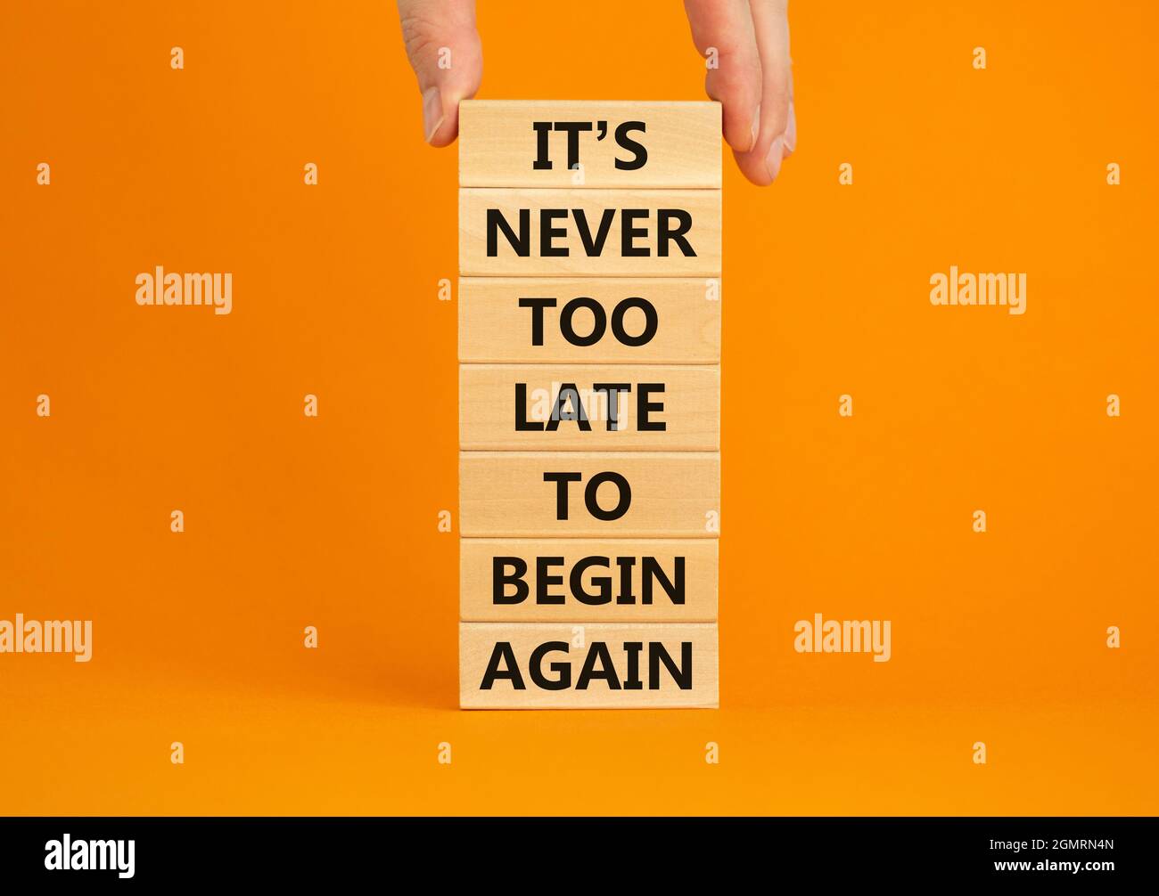 Begin again symbol. Wooden blocks with words 'It is never too late to ...
