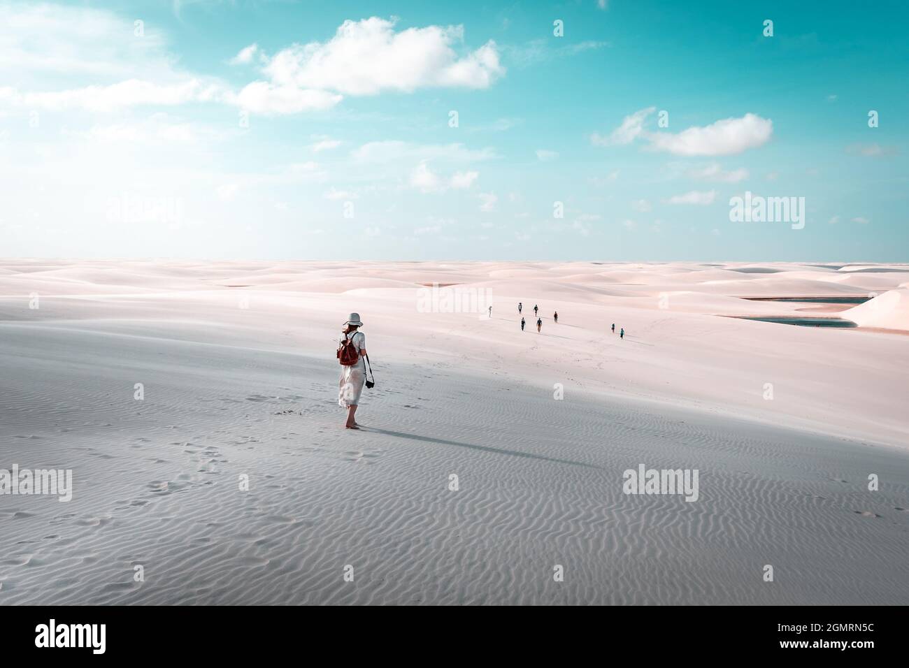 Beautiful view of a person walking in a desert with sand dunes in the ...