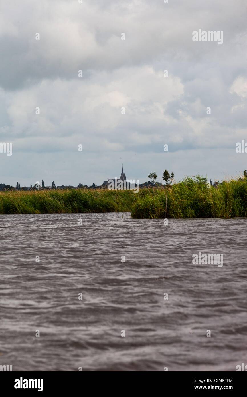 Vertical shot of a calm lake with a church in the background Stock ...