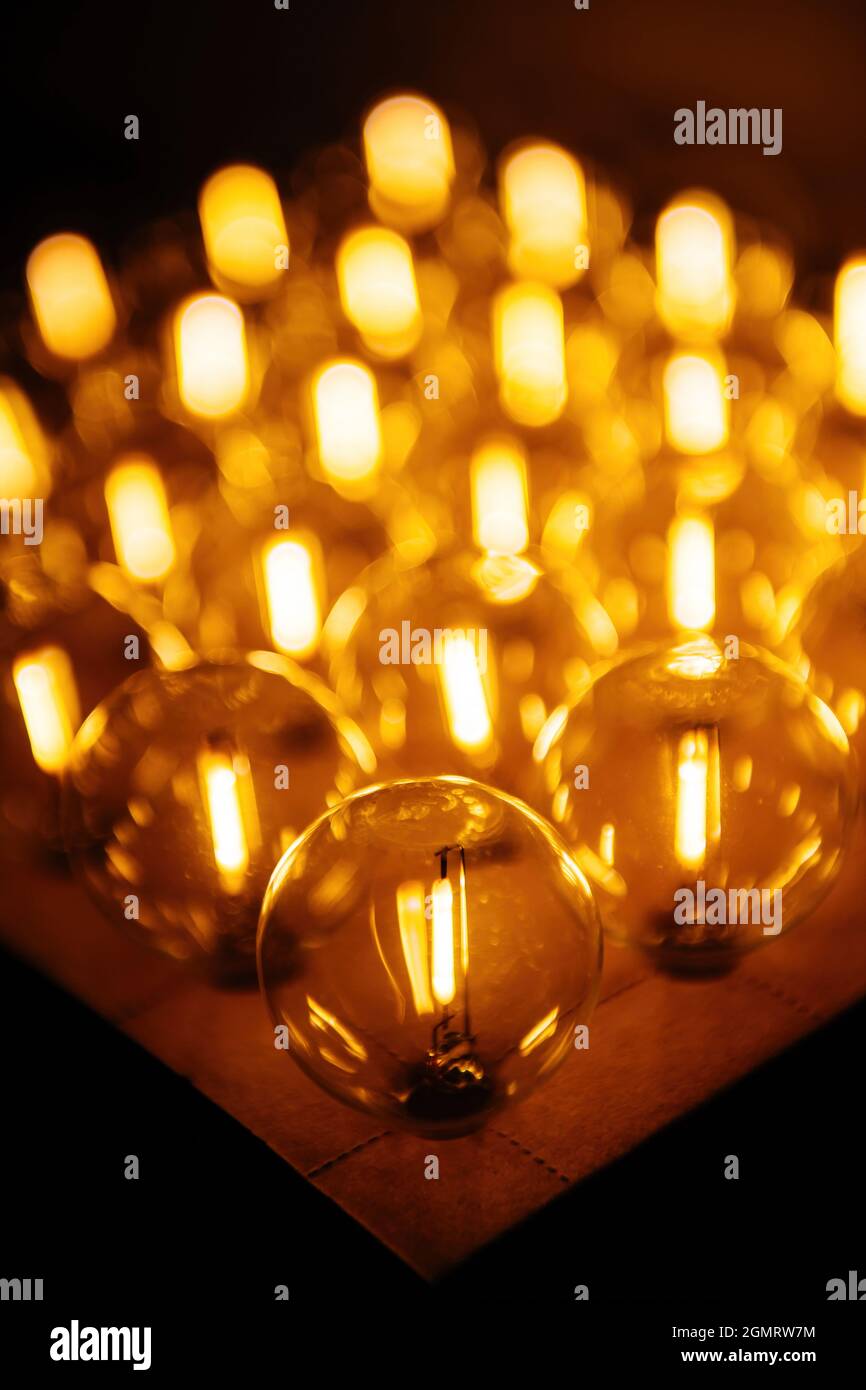 Multiple led lights in a row with yellow filament - defocus background ...