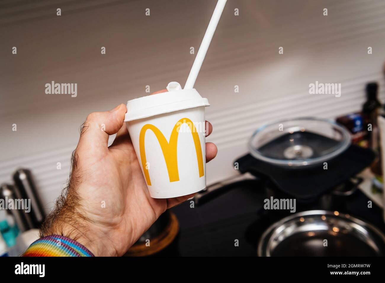 POV male hand holding plastic cup with McDonald's logotype on it and ...