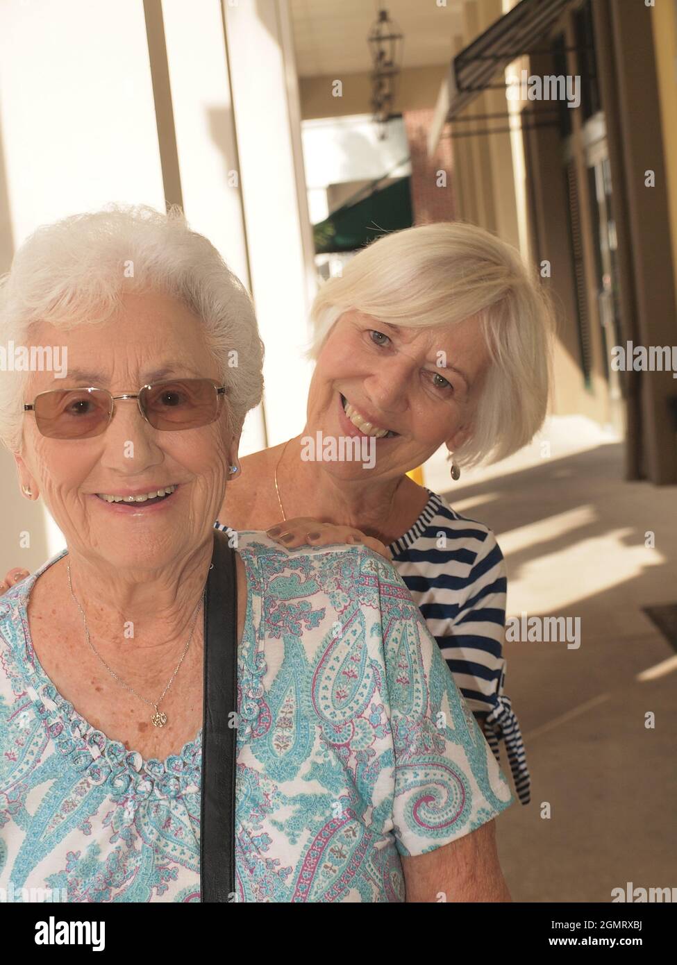 Two attractive women cousins enjoying togetherness in the warm summer ...