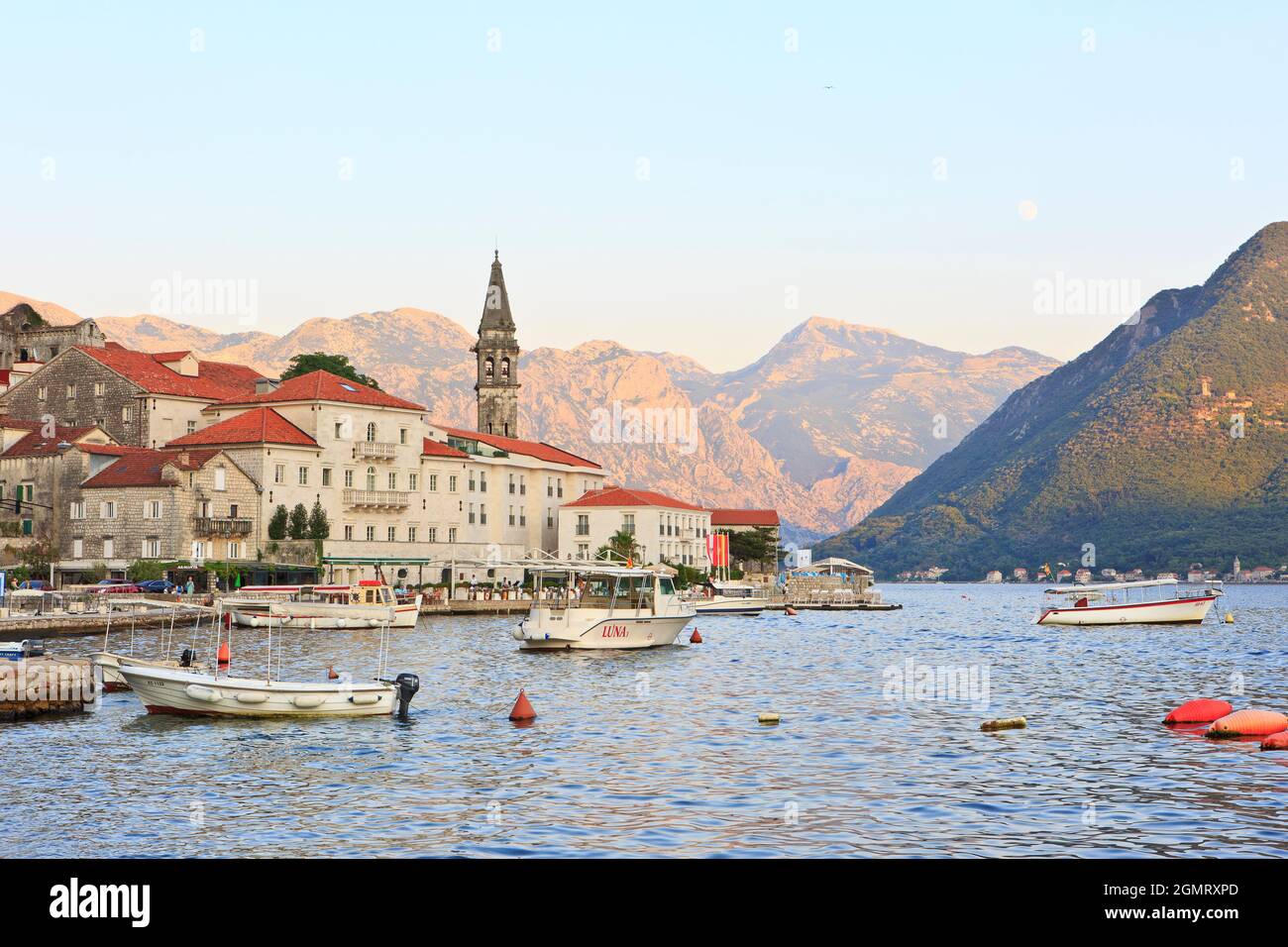 A view of the picturesque old town of Perast in Montenegro at dusk ...