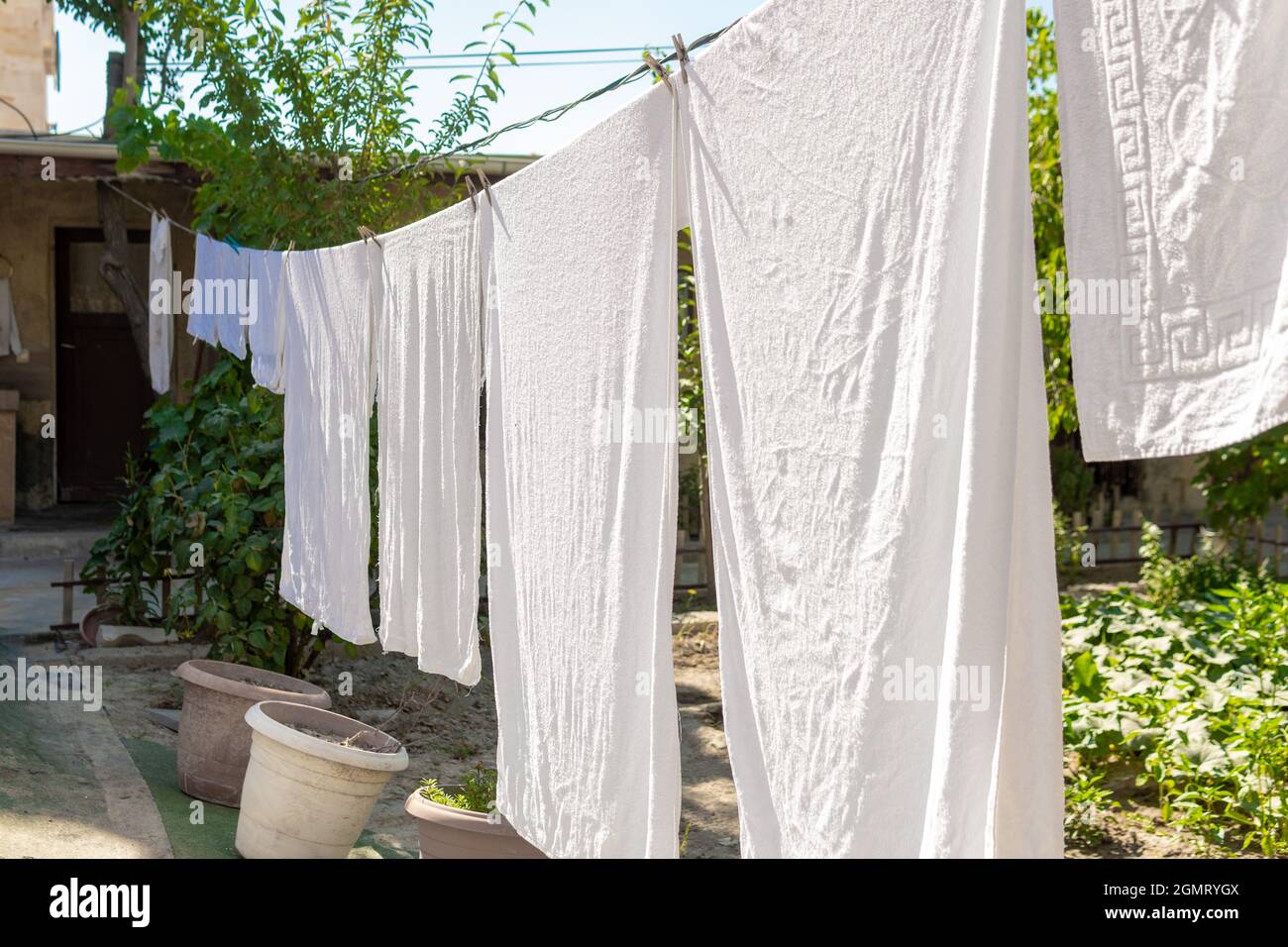 Hanging laundry, white laundry waiting to dry in a sunny weather Stock ...