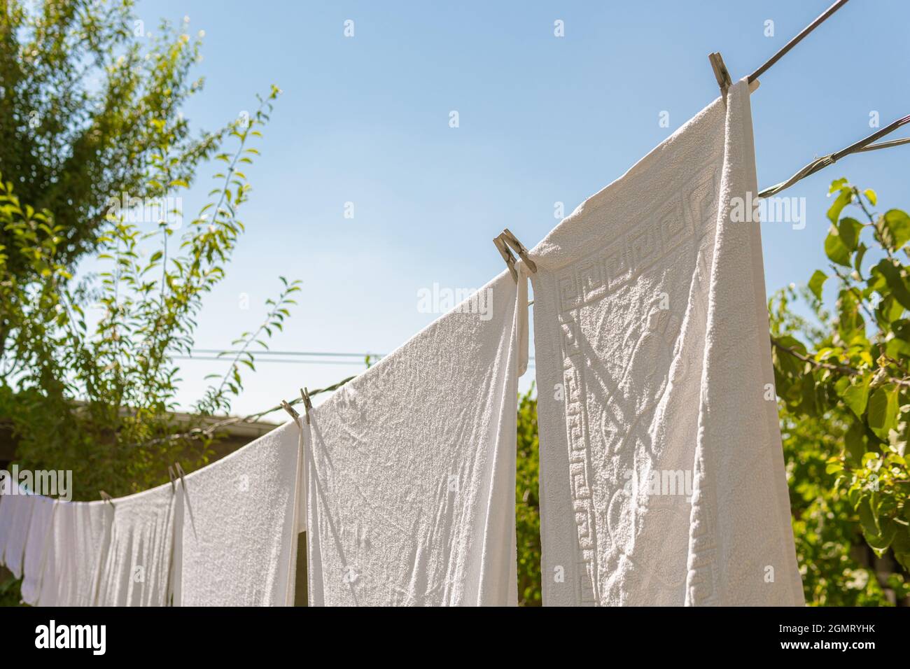 Hanging laundry, white laundry waiting to dry in a sunny weather Stock ...