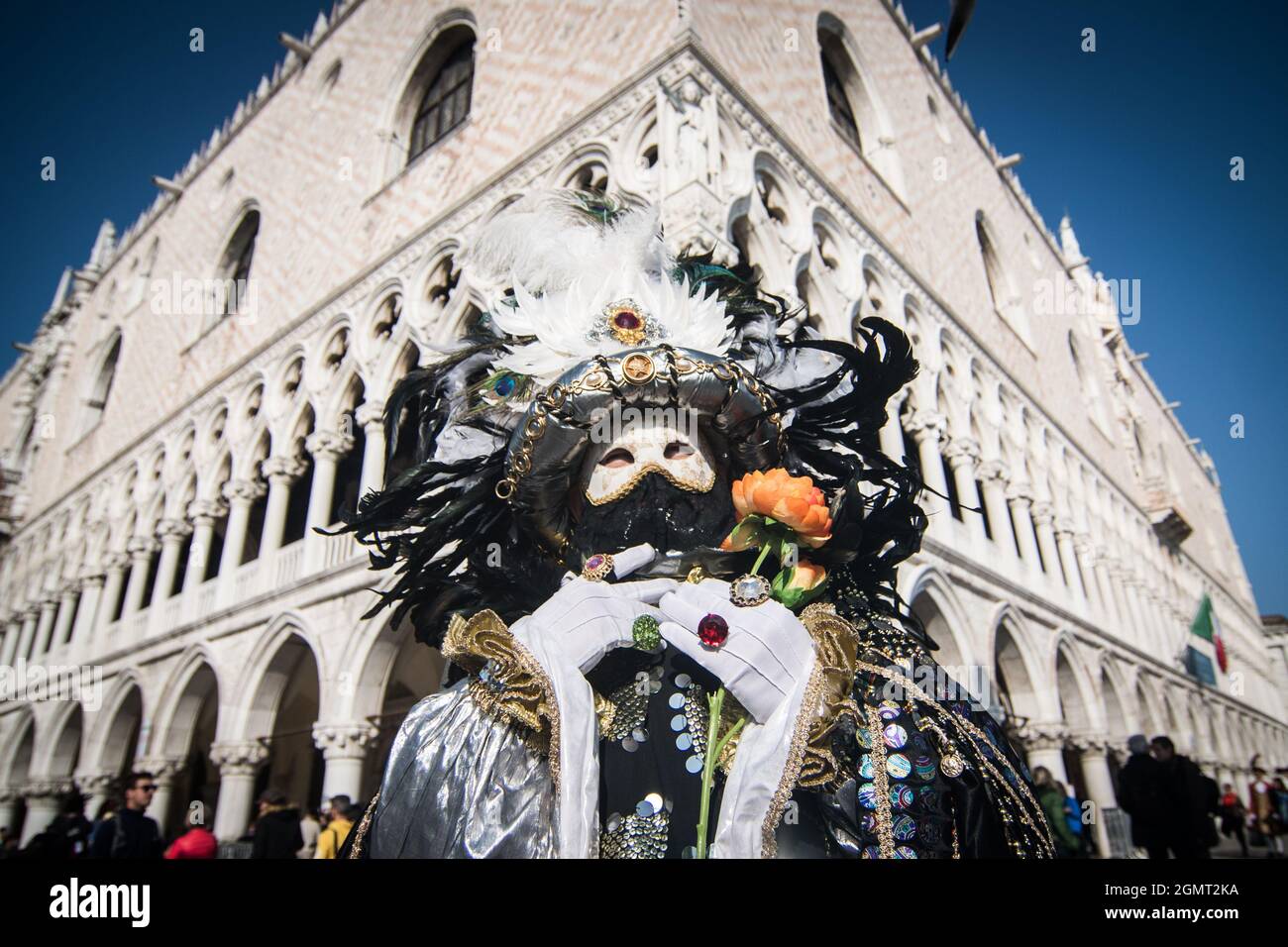 Person dressed in a fabulous Carnival costume and mask in front of ...