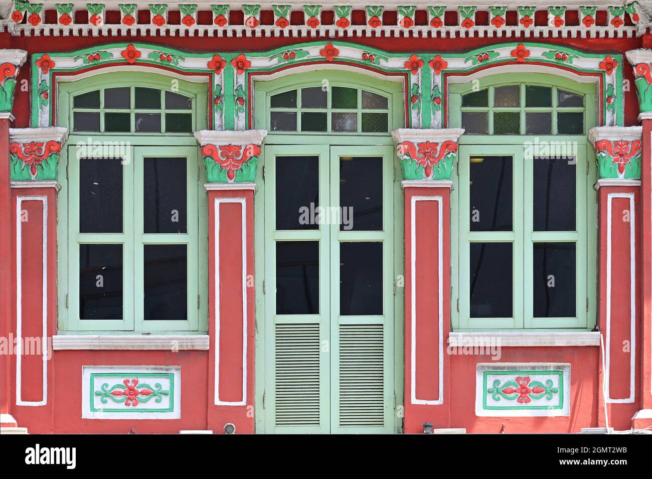 Red Singapore Straits Chinese Peranakan shop house exterior with arched ...