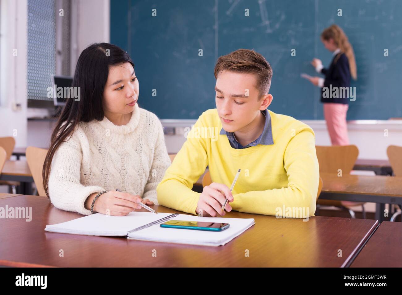 Chinese girl student helping friend prepare for exam Stock Photo - Alamy