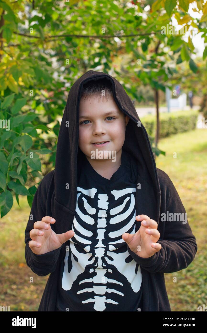 Little boy in a skeleton costume is ready to celebrate Halloween. Boy ...