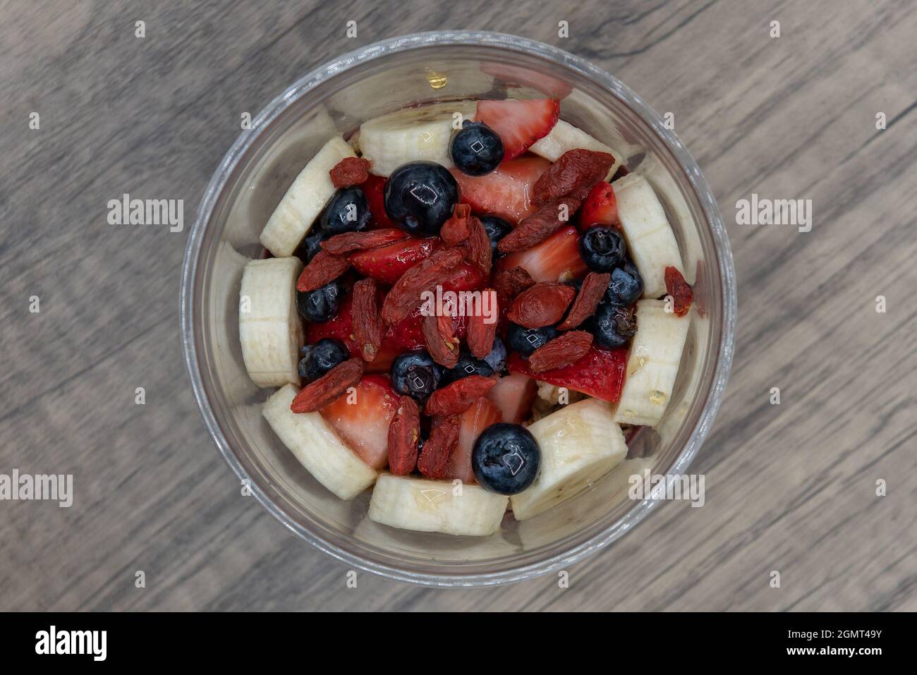 Overhead view of acai fruit bowl blueberries, strawberry, and goji ...