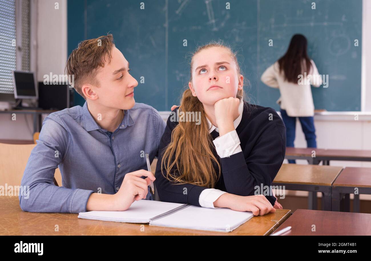 Teenager supporting female classmate Stock Photo - Alamy