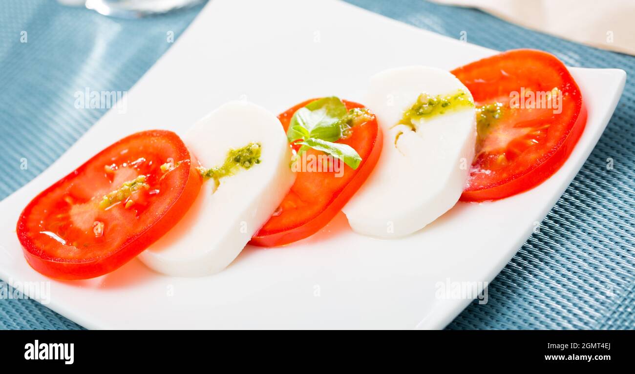 Appetizing salad with young white cheese Stock Photo - Alamy