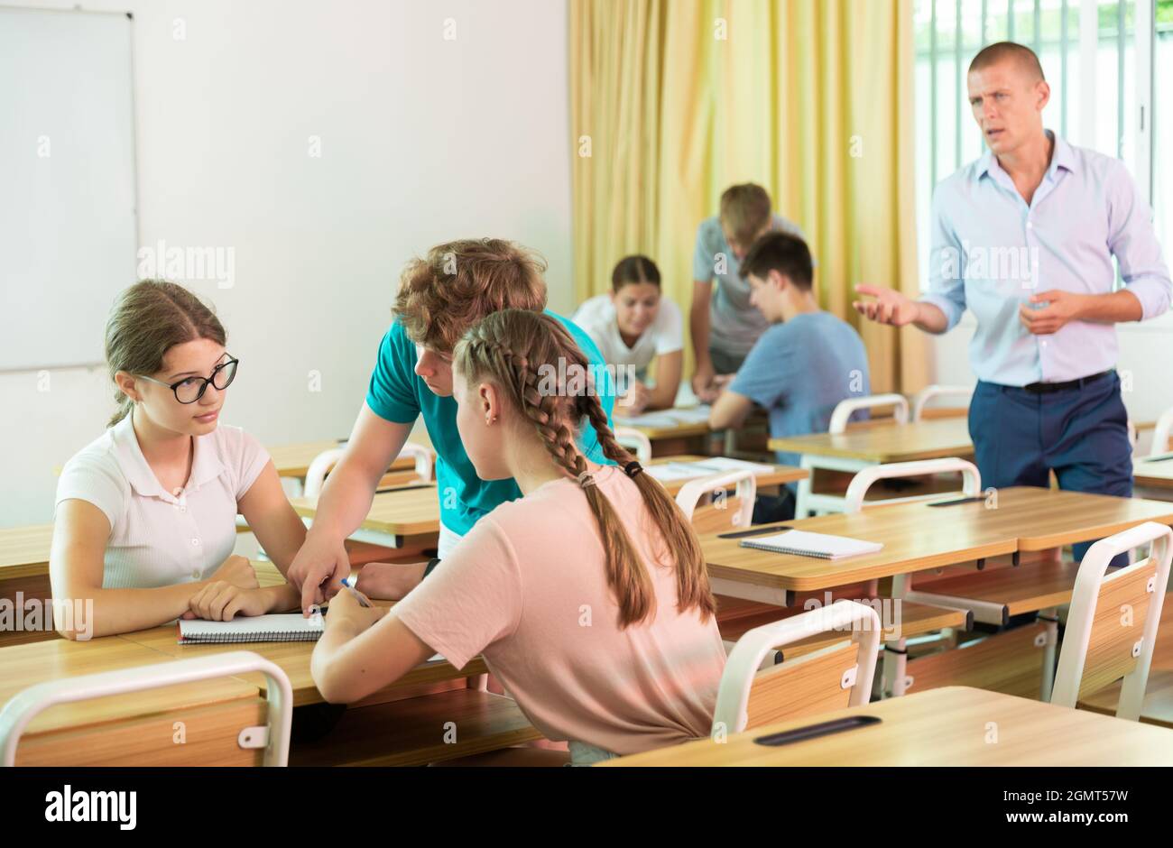 Fellow students having group work tasks during school Stock Photo - Alamy