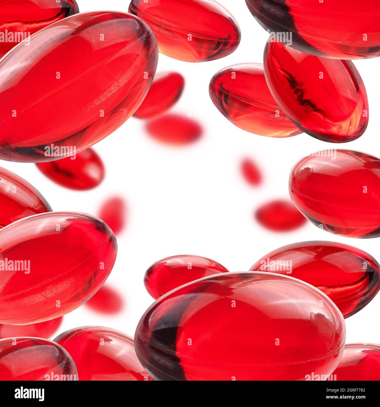 Red capsules levitate on a white background Stock Photo - Alamy
