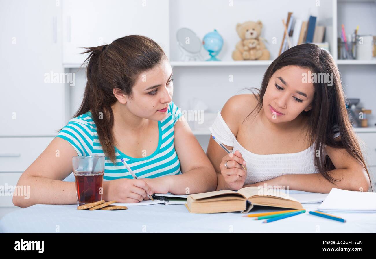 Two classmates doing homework together Stock Photo - Alamy